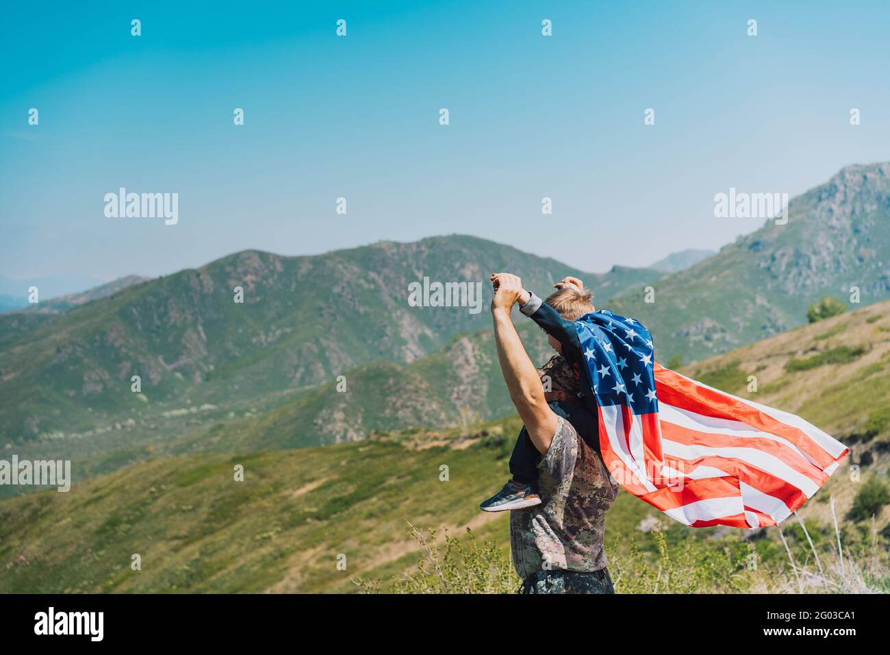 Man and child celebrate fourth of july with american flag in nature ...