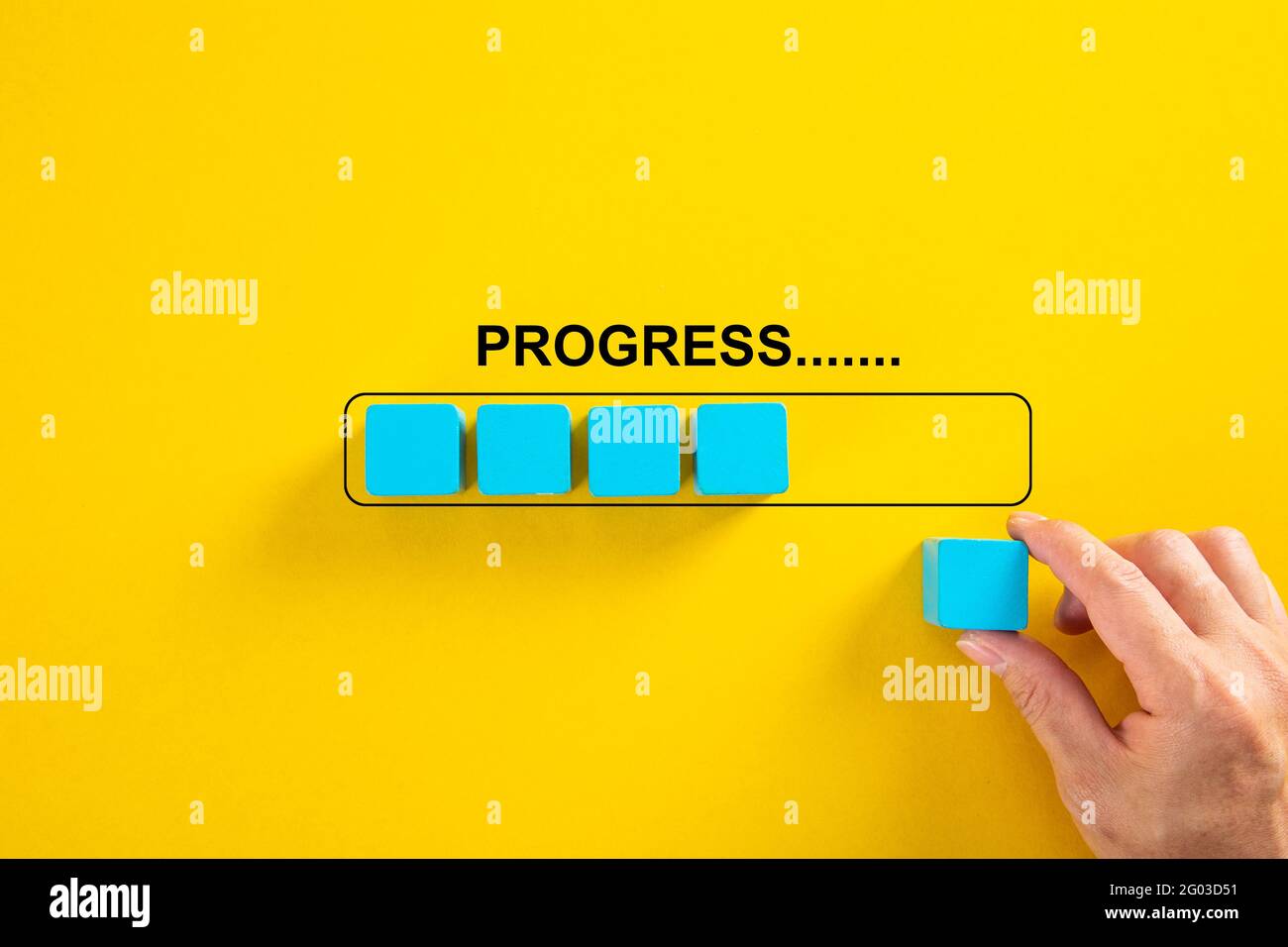 Hand putting wooden cube on virtual infographic rectangleblock with ...