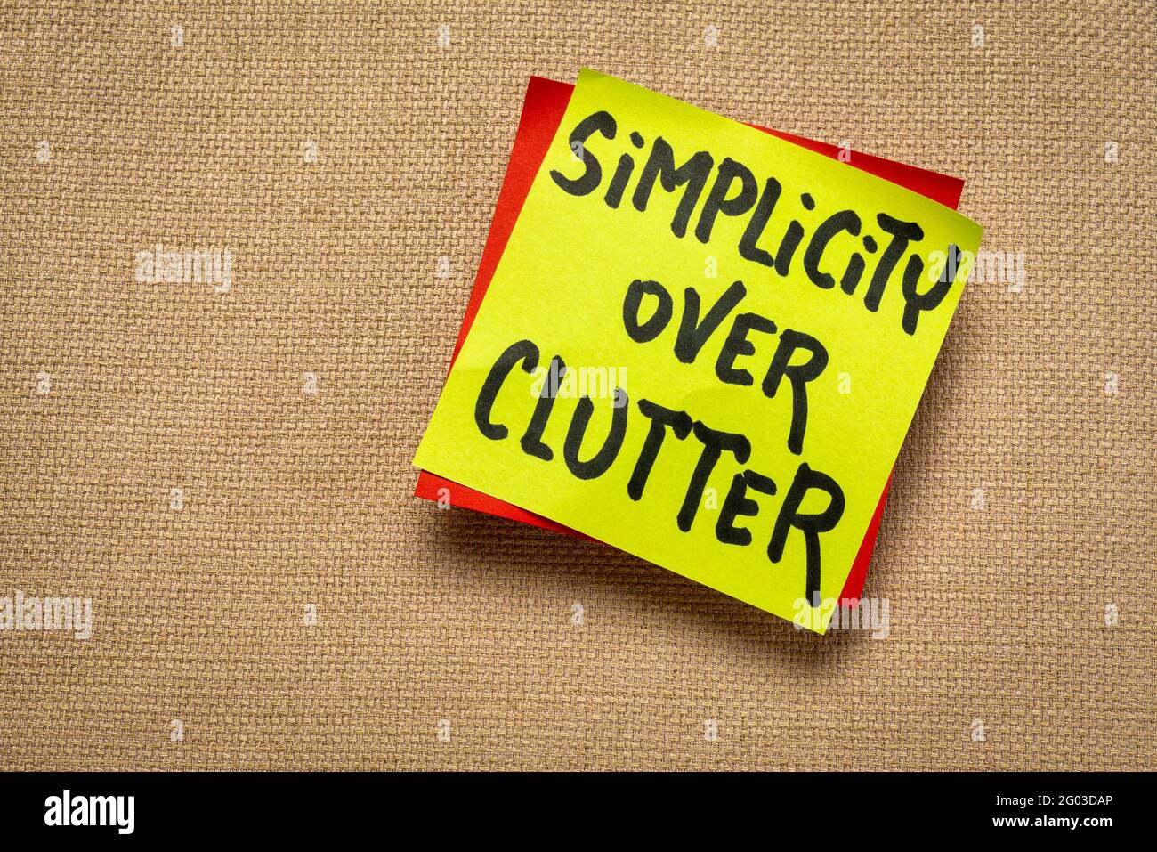 simplicity over clutter inspirational concept, handwriting on a sticky ...