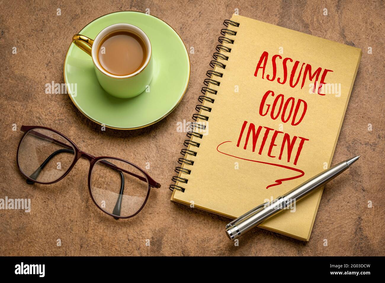 assume good intent inspirational handwriting in a spiral notebook with ...