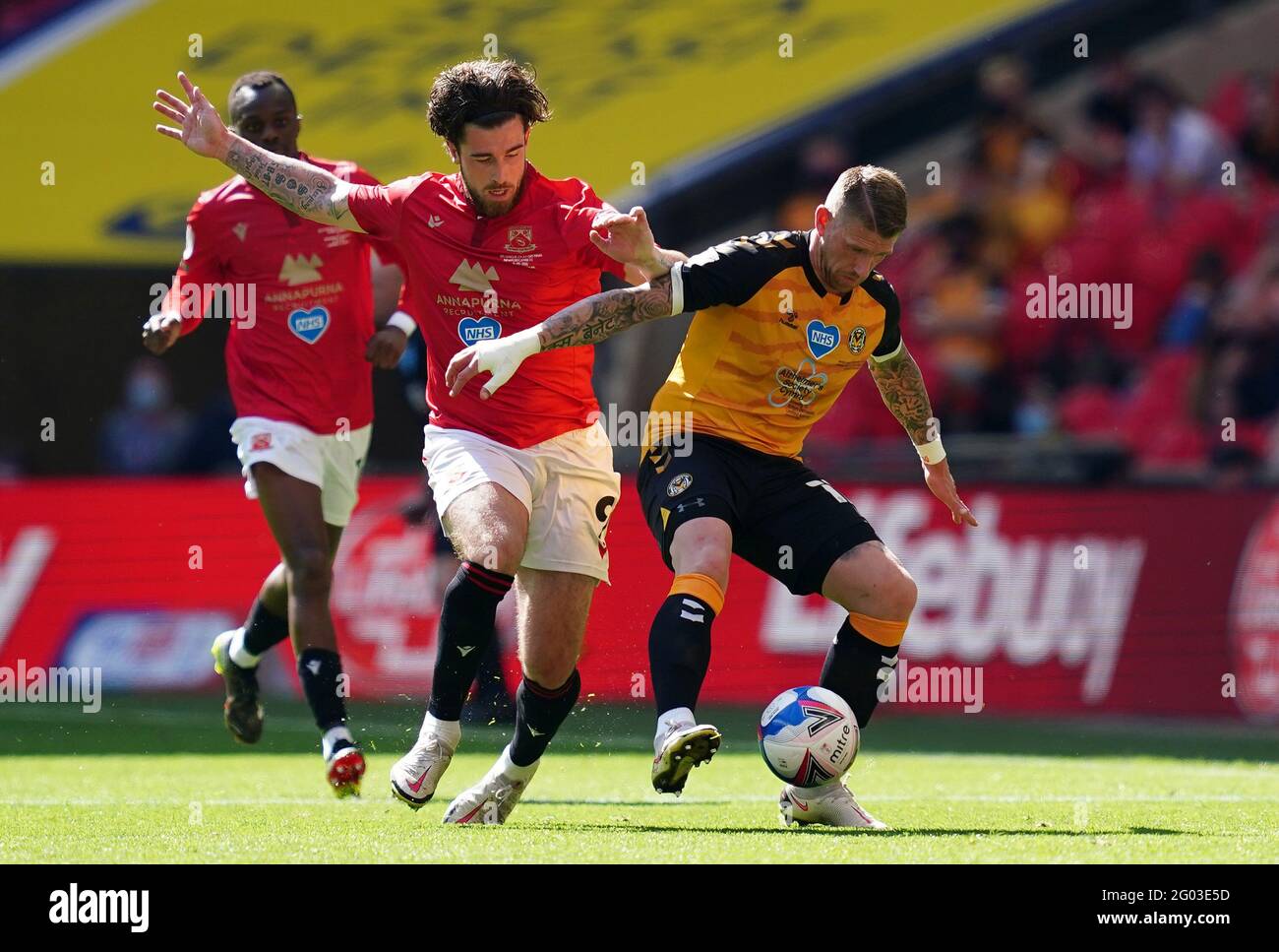 Morecambe's Cole Stockton (left) and Newport County's Scot Bennett ...