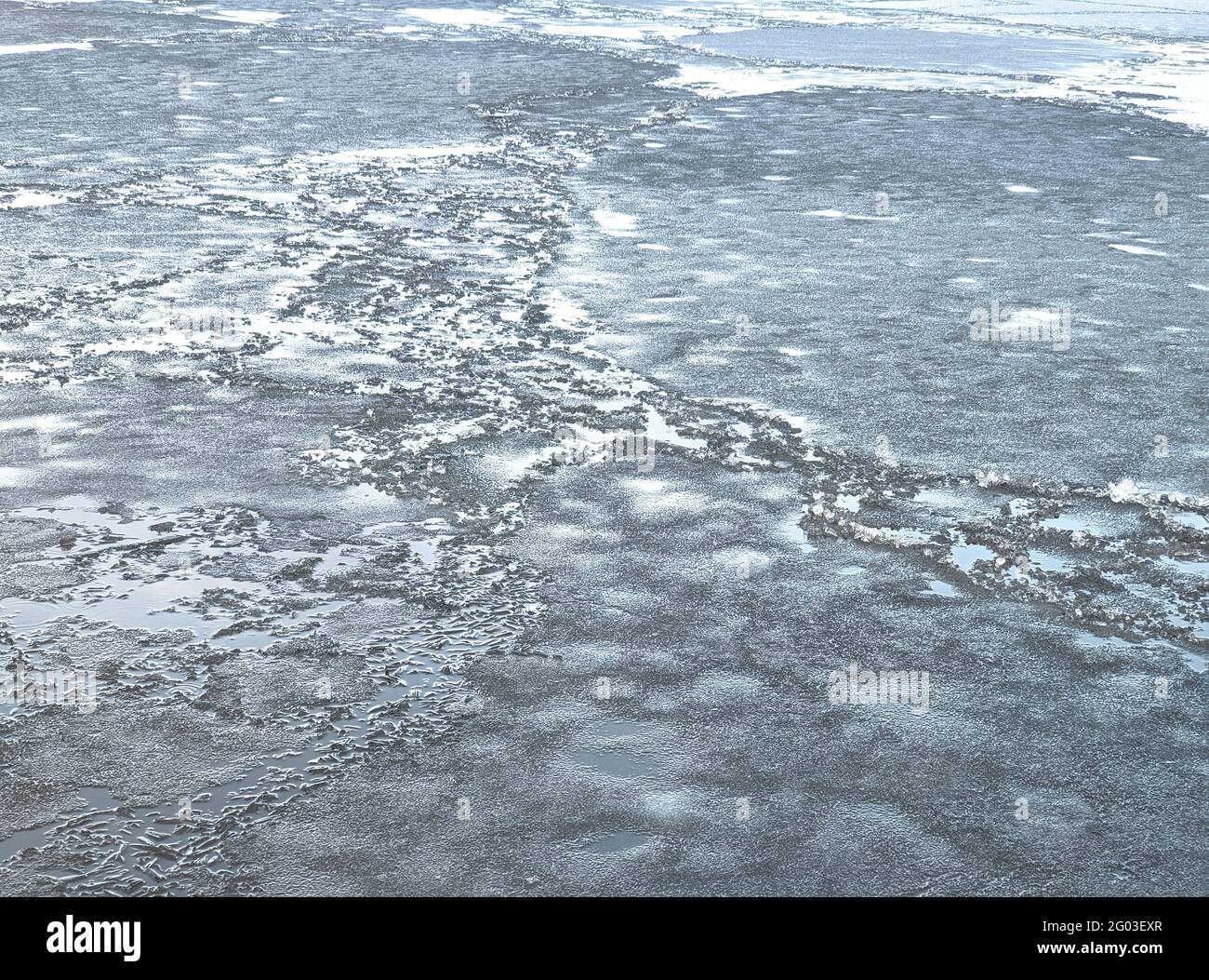 Broken ice of dark blue color on the river. Chunks of crushed ice on ...