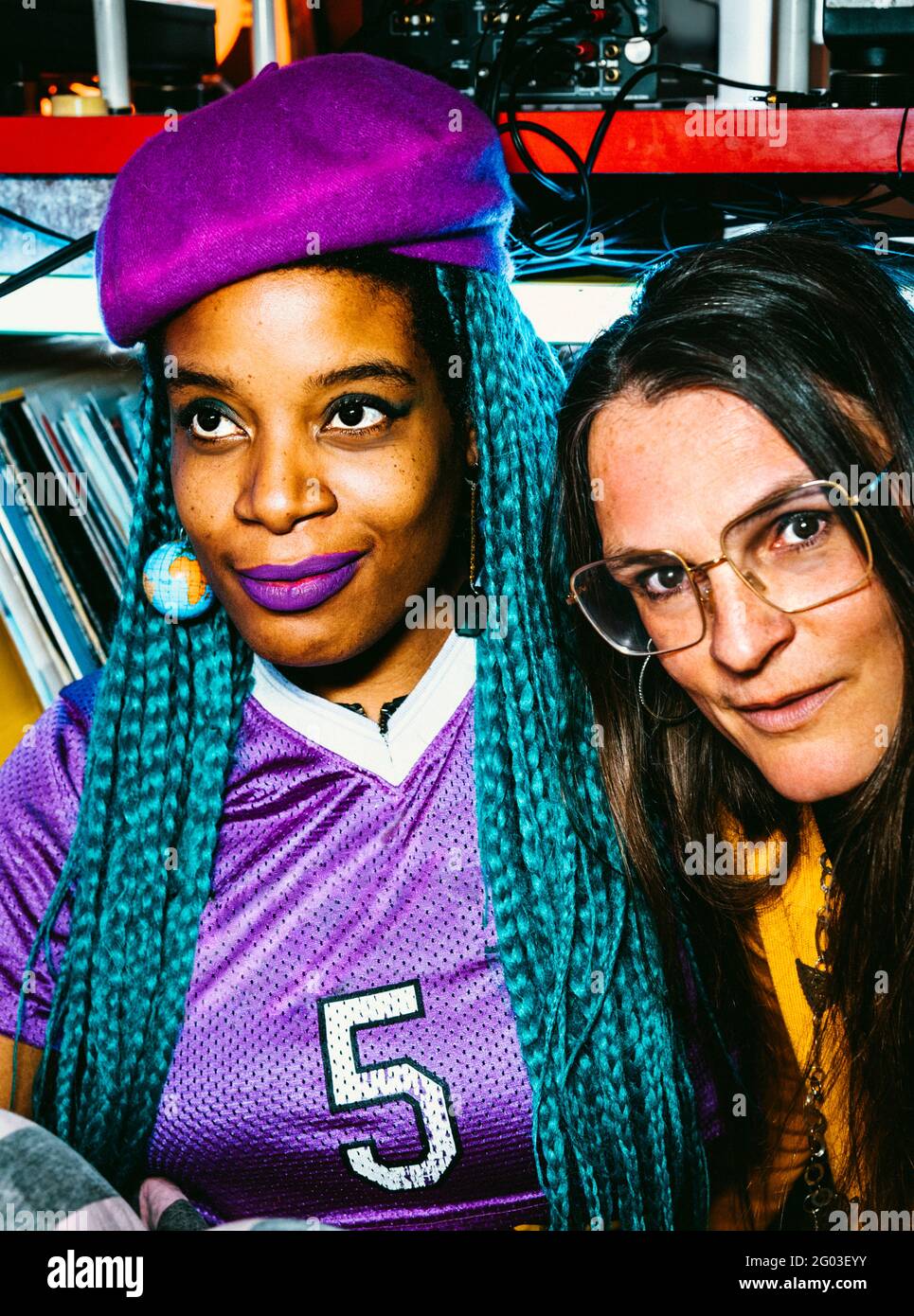 Portrait of smiling woman sitting with female friend looking away Stock ...