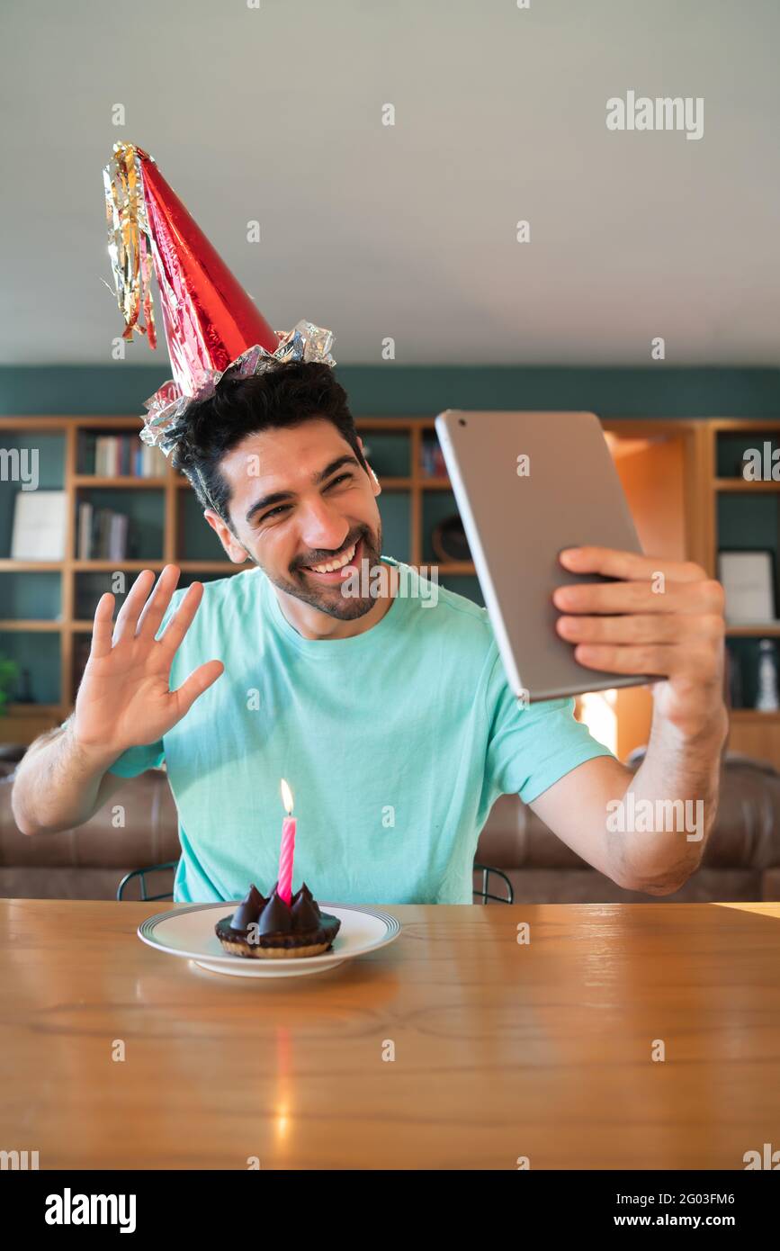 Man celebrating his birthday on a video call Stock Photo - Alamy