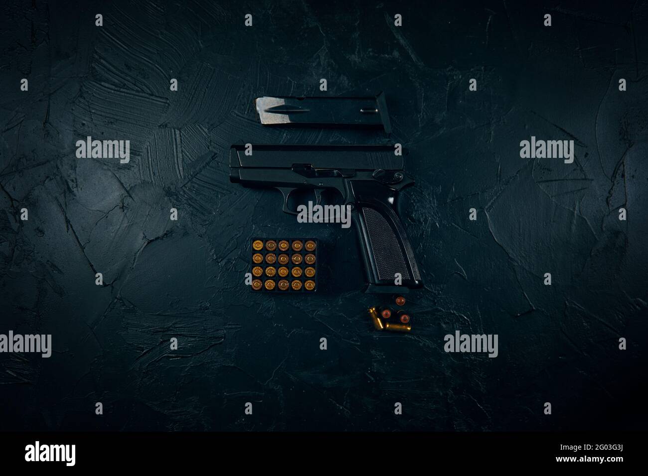 Gun and bullets on concrete background. Top view of neatly arranged ...