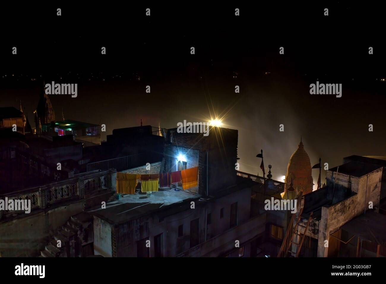 Wide angle Night view showing rooftop of random houses with clothes ...