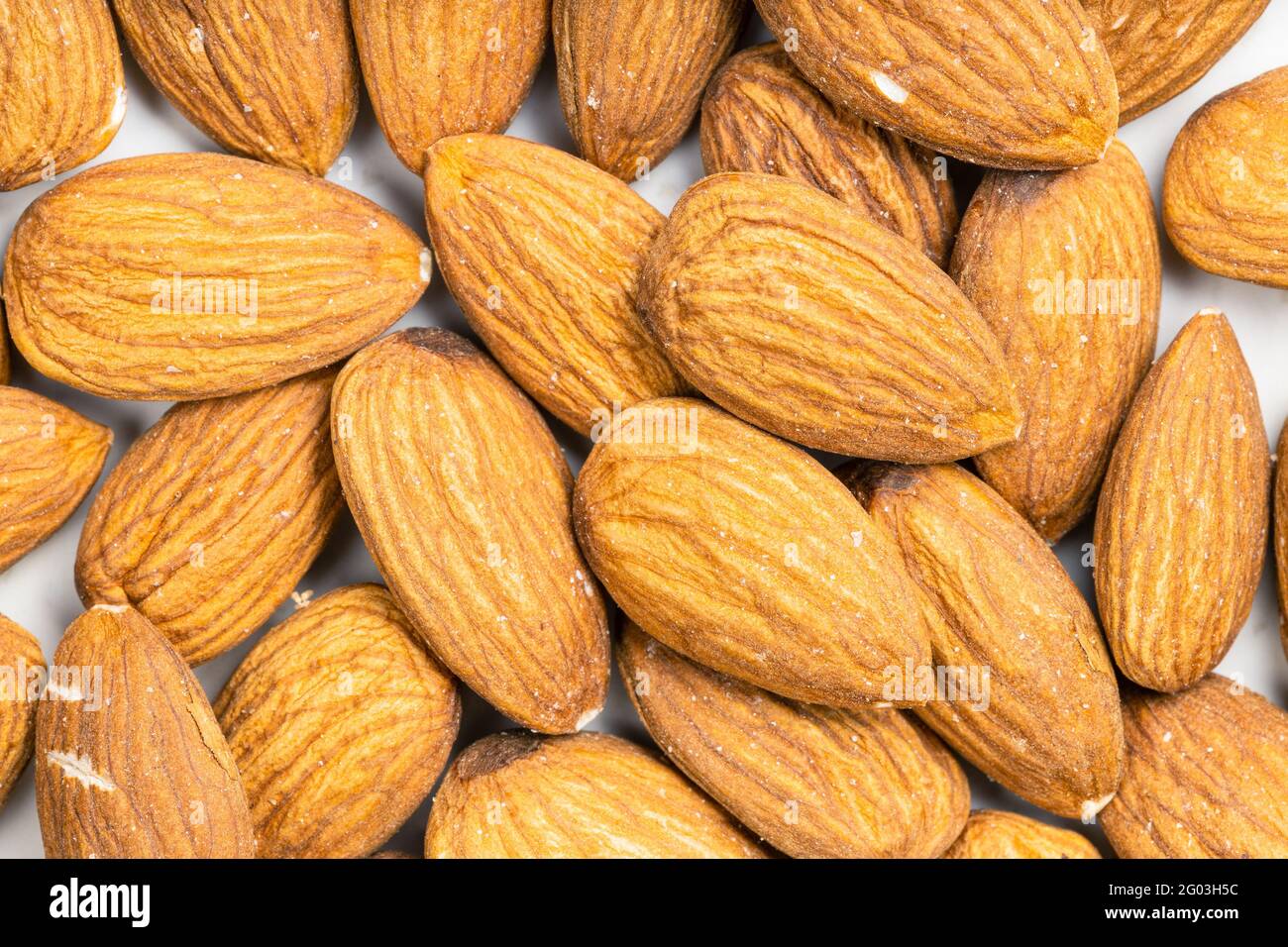 food background - many raw almond seeds Stock Photo - Alamy