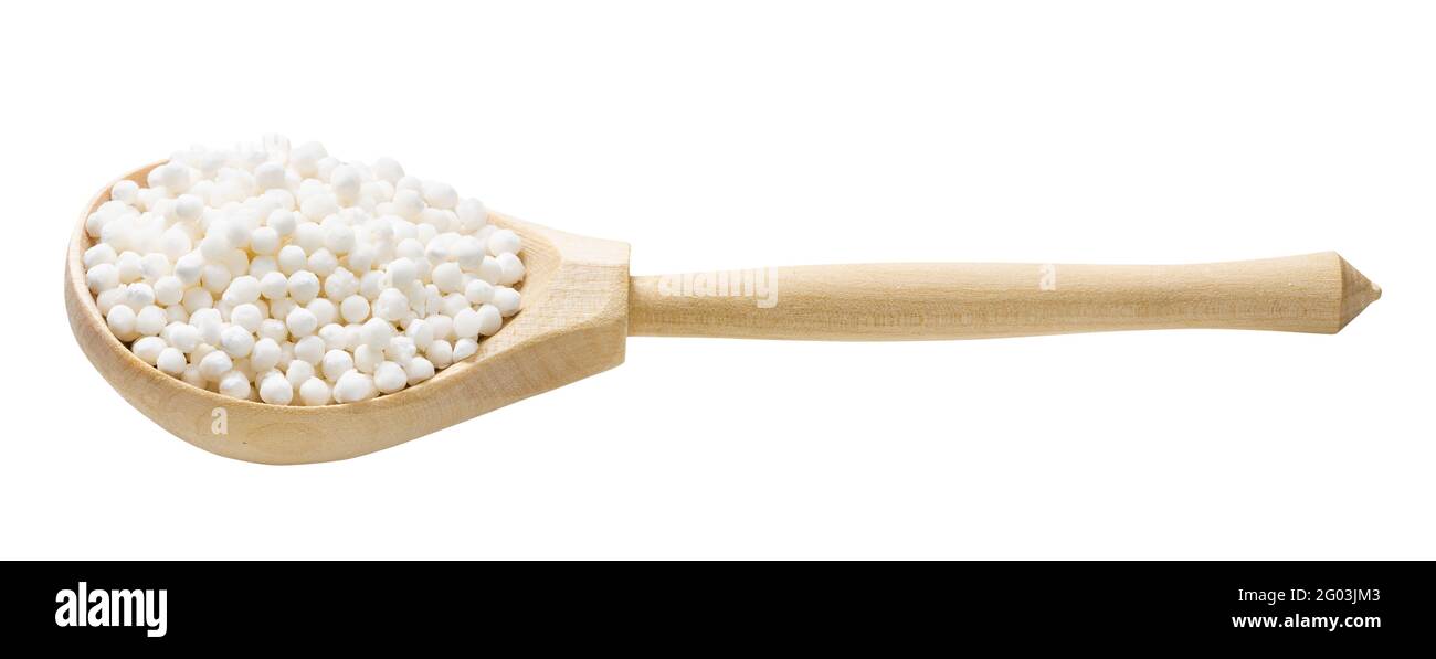 dry sabudana (tapioca sago) in wooden spoon isolated on white ...