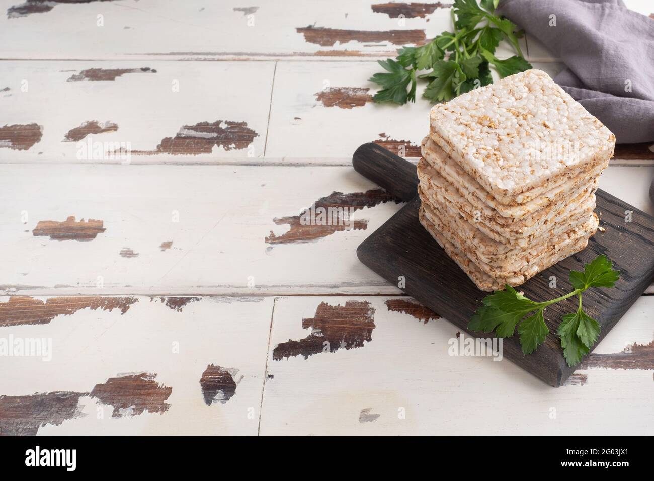 Healthy snack Crunchy crispbread with fresh parsley leaves. Wooden ...