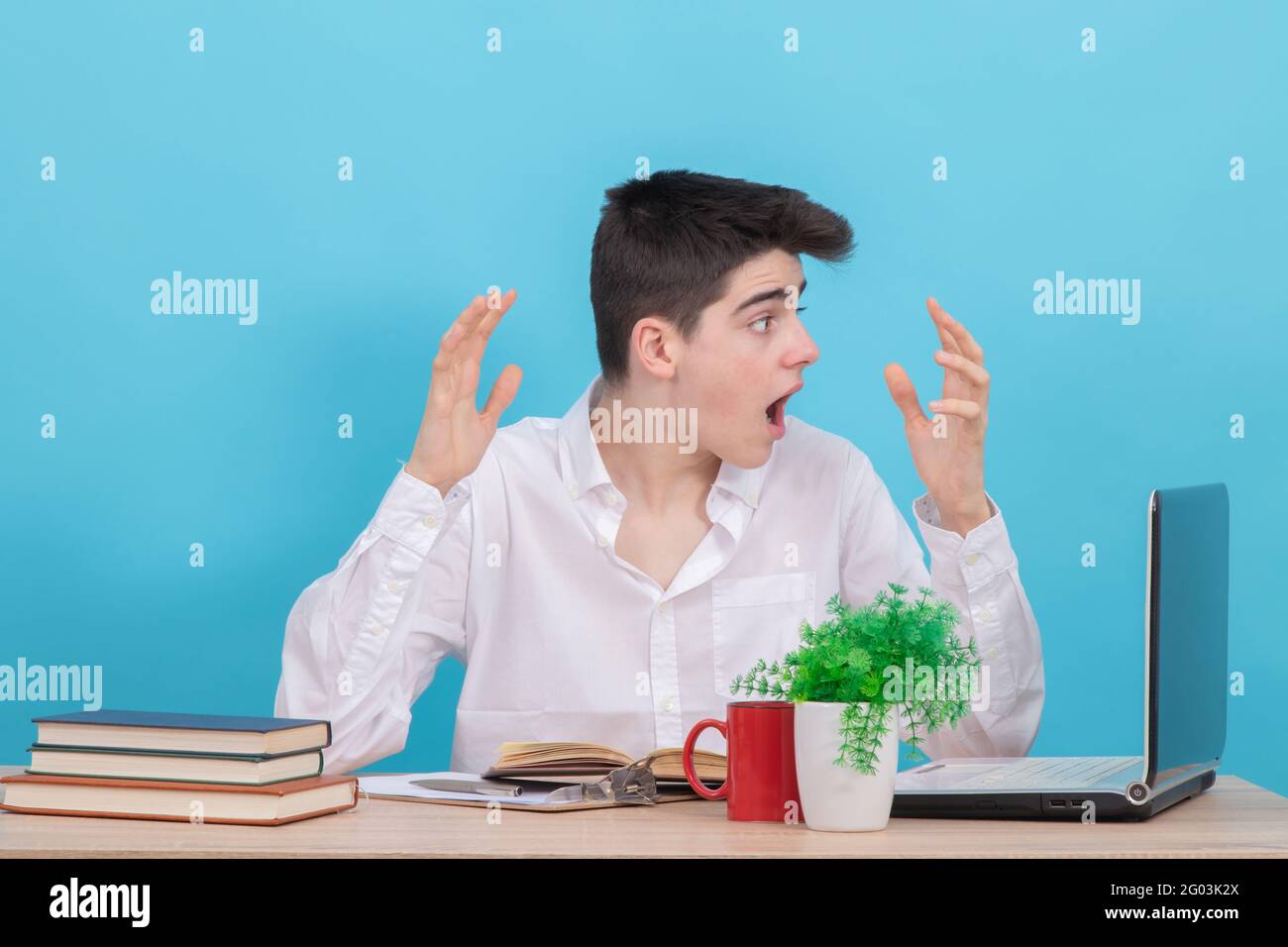 teenage student at the desk with computer and colored background Stock ...