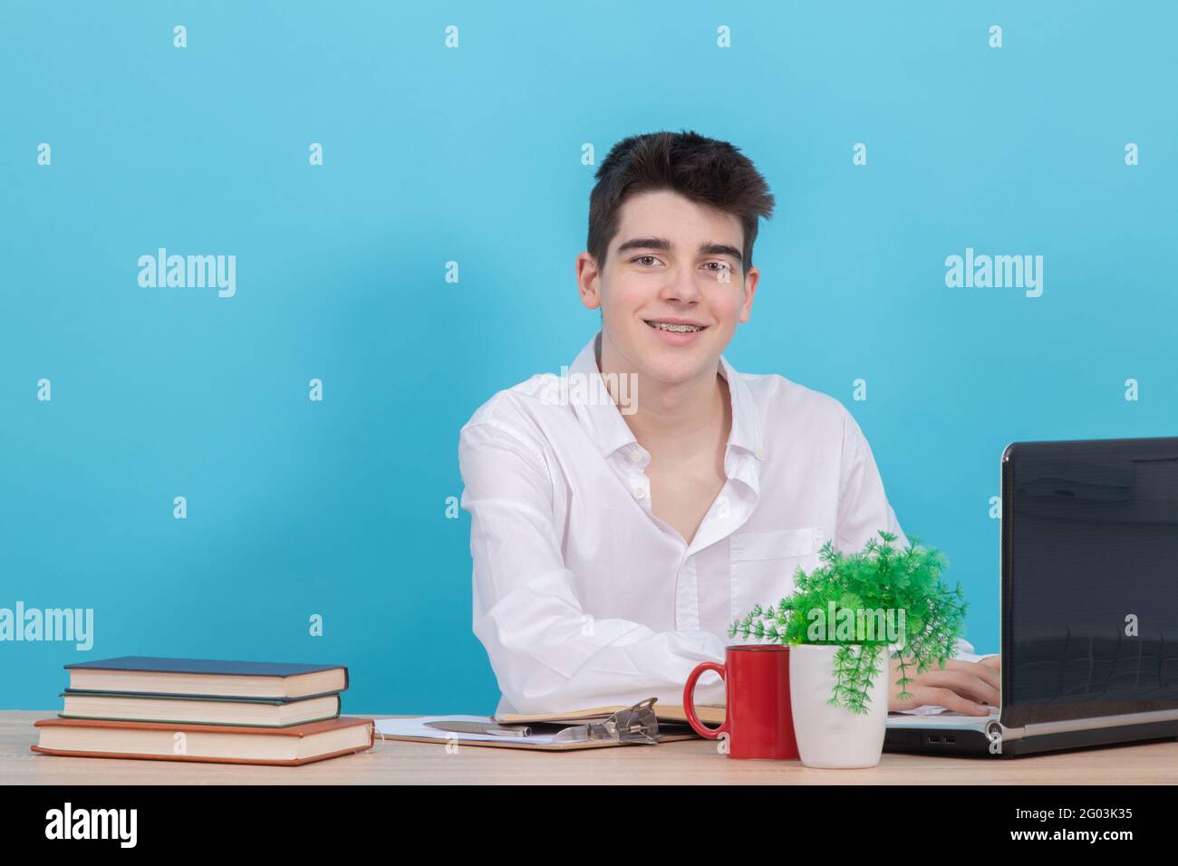 teenage student at the desk with computer and colored background Stock ...