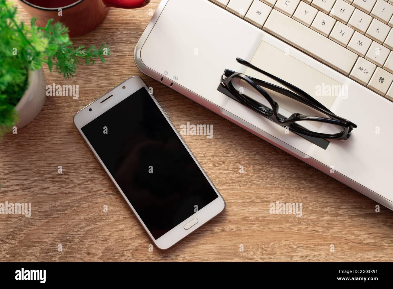 top view of mobile phone on desktop Stock Photo - Alamy