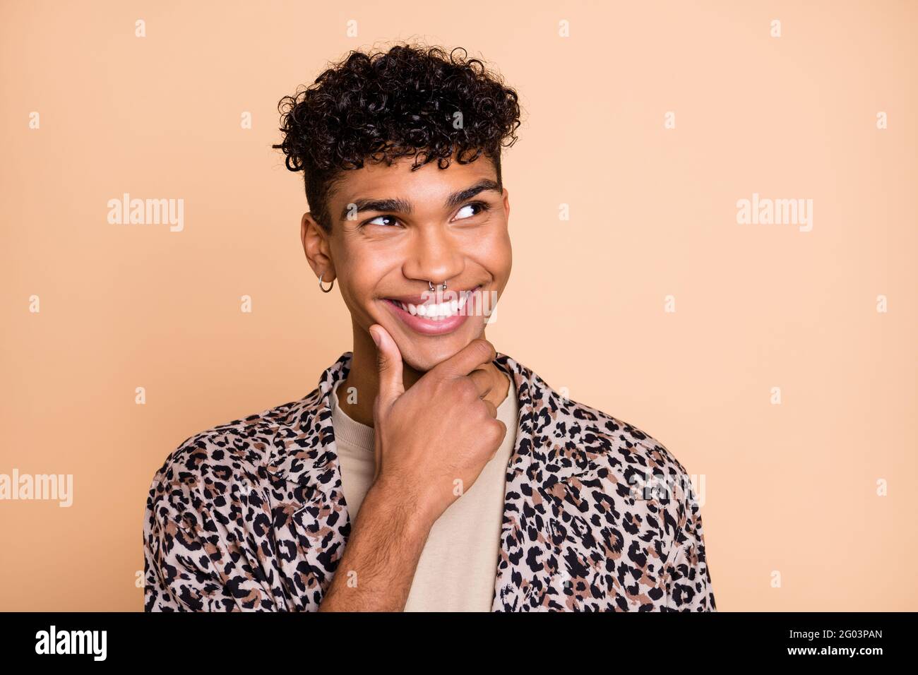 Portrait of brunet optimistic guy hand chin look empty space wear ...