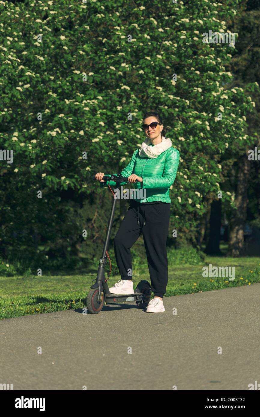 Woman on an electric scooter hi-res stock photography and images - Alamy