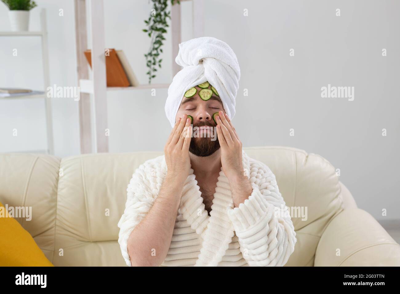 Bearded man enjoys with a cosmetic mask on his face made from slices of ...