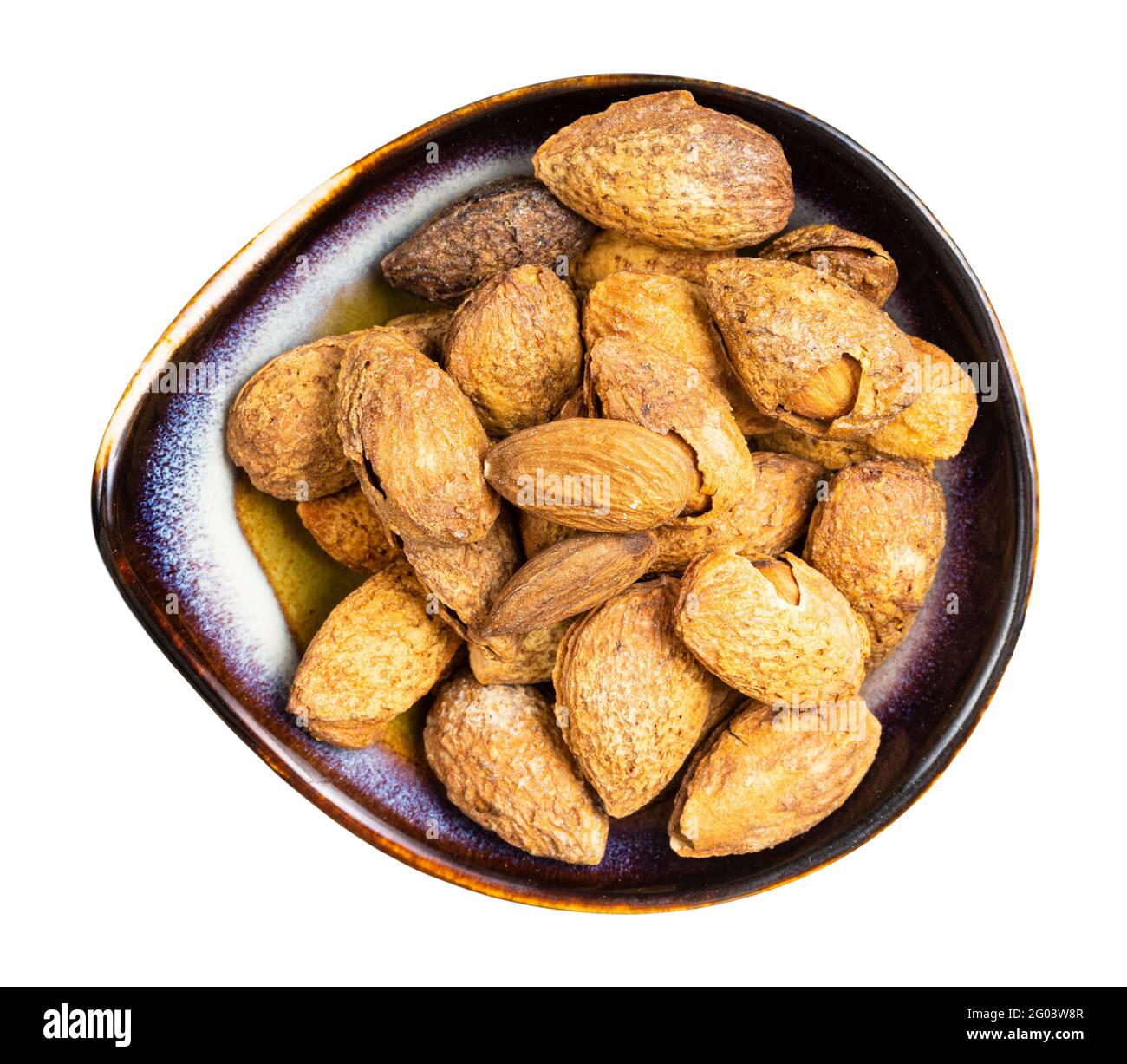 top view of almond seeds and drupes in ceramic bowl isolated on white ...