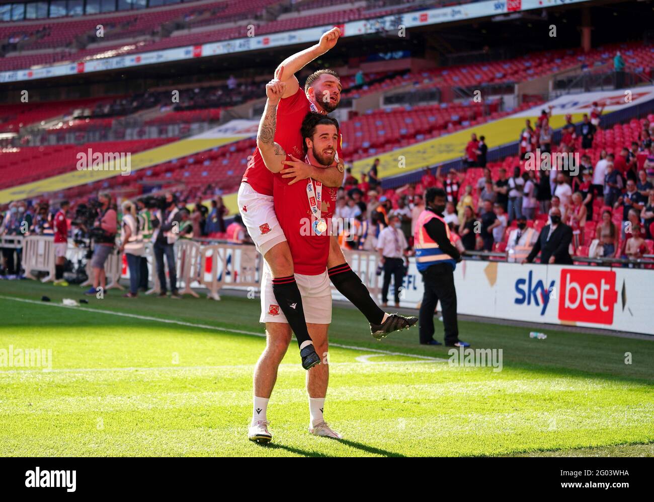 Morecambe's Alex Kenyon (left) and Cole Stockton celebrate after the ...