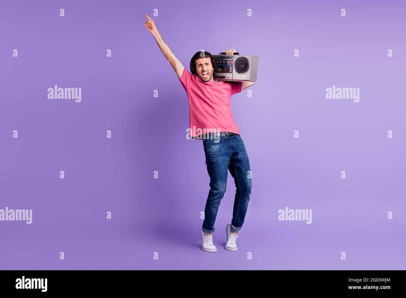 Full size photo of optimistic nice brunet guy listen boom box wear pink ...