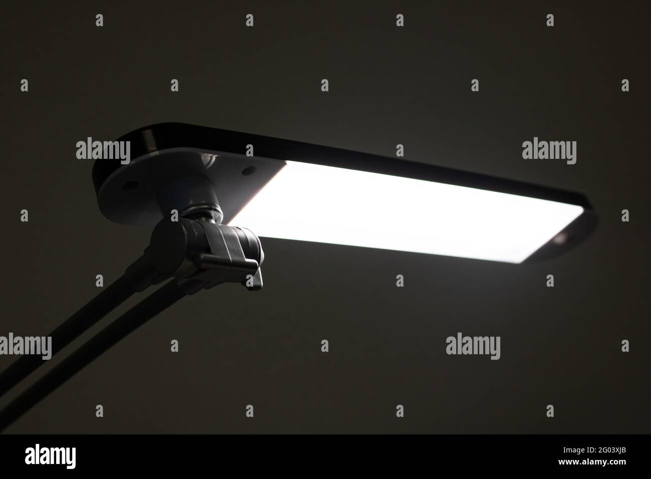 Table fluorescent lamp shines in the dark close up Stock Photo - Alamy