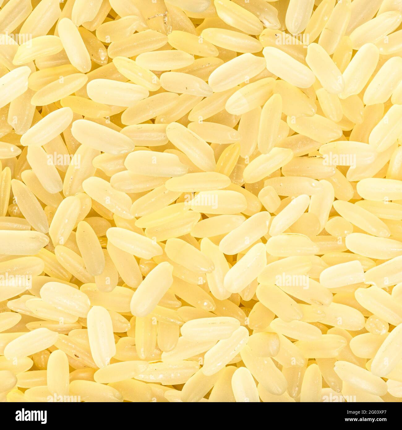 square food background - raw parboiled long-grain rice close up Stock ...