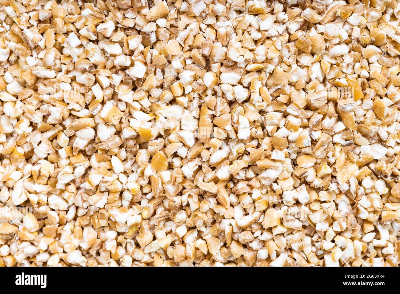 food background - uncooked wheat groats (crushed partly hulled wheat ...