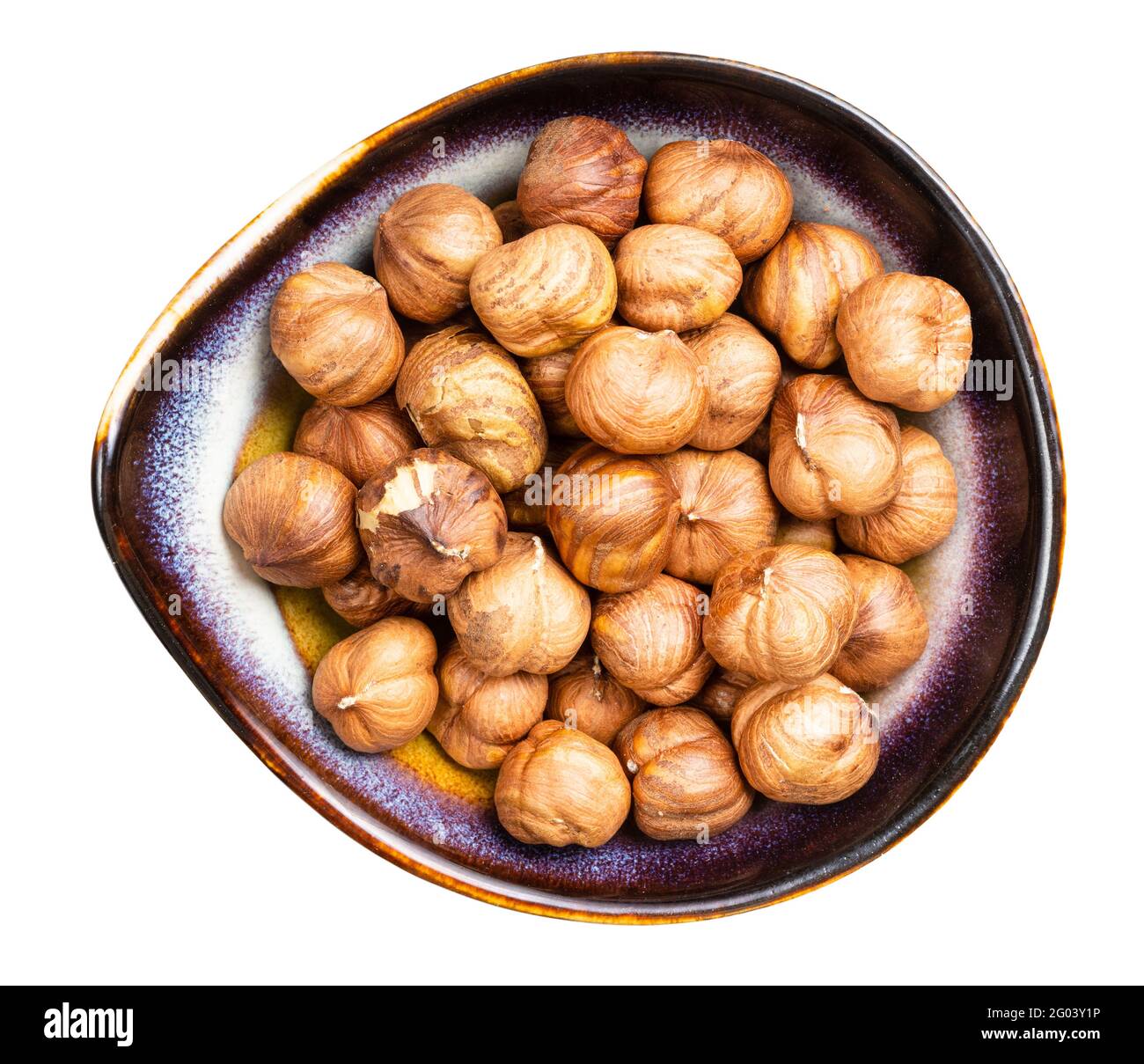 top view of shelled hazelnuts in ceramic bowl isolated on white ...