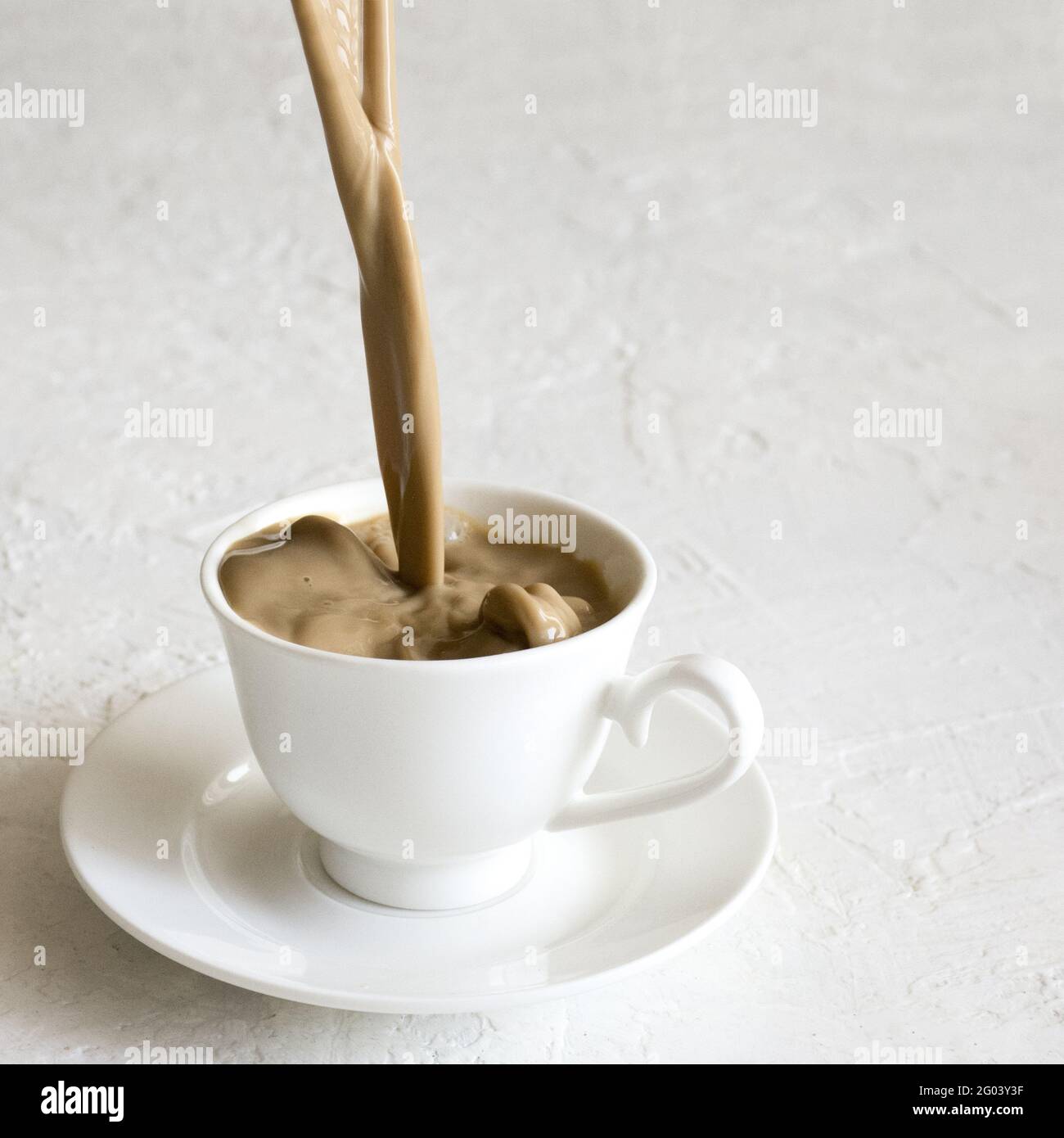 Pouring life into a cup Stock Photo - Alamy