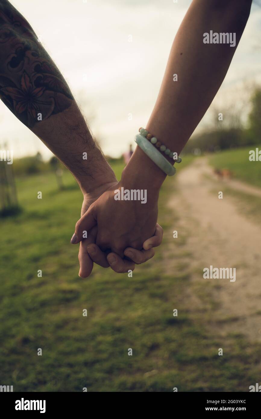 Loving couple holding hands together Stock Photo - Alamy