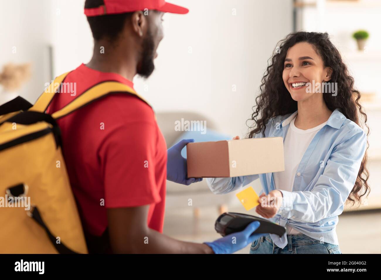 Portrait of black man holding POS machine for payment Stock Photo - Alamy