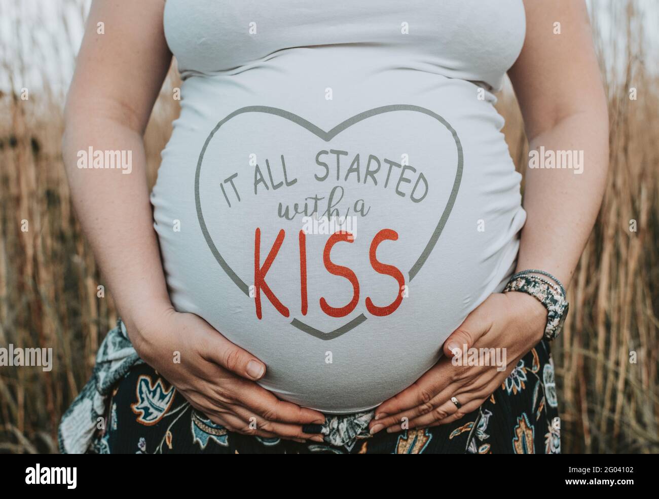 Midsection image of pregnant woman standing outdoor in field and ...