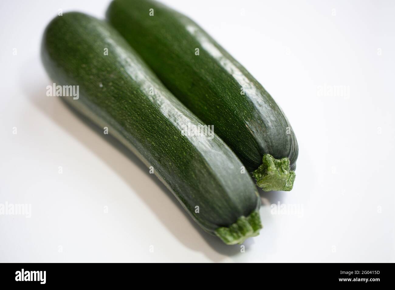 Zucchini on white background Stock Photo - Alamy