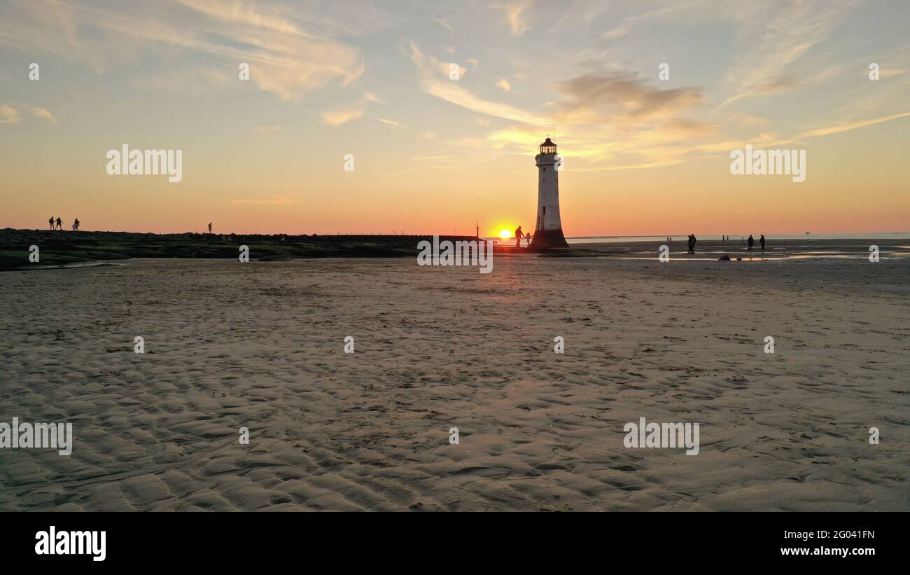 Sun setting behind New Brighton lighthouse Stock Photo - Alamy
