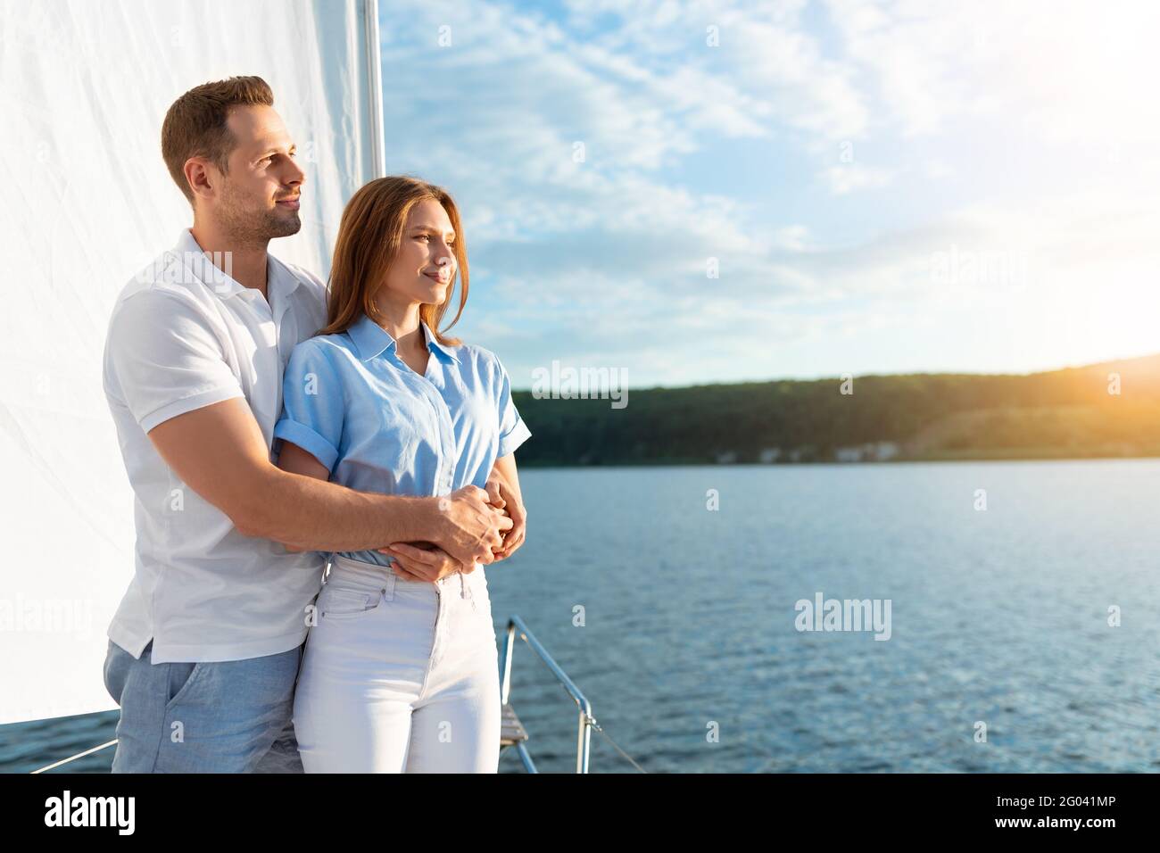 Loving Couple Enjoying Sailboat Ride Hugging Standing On Yacht Deck ...
