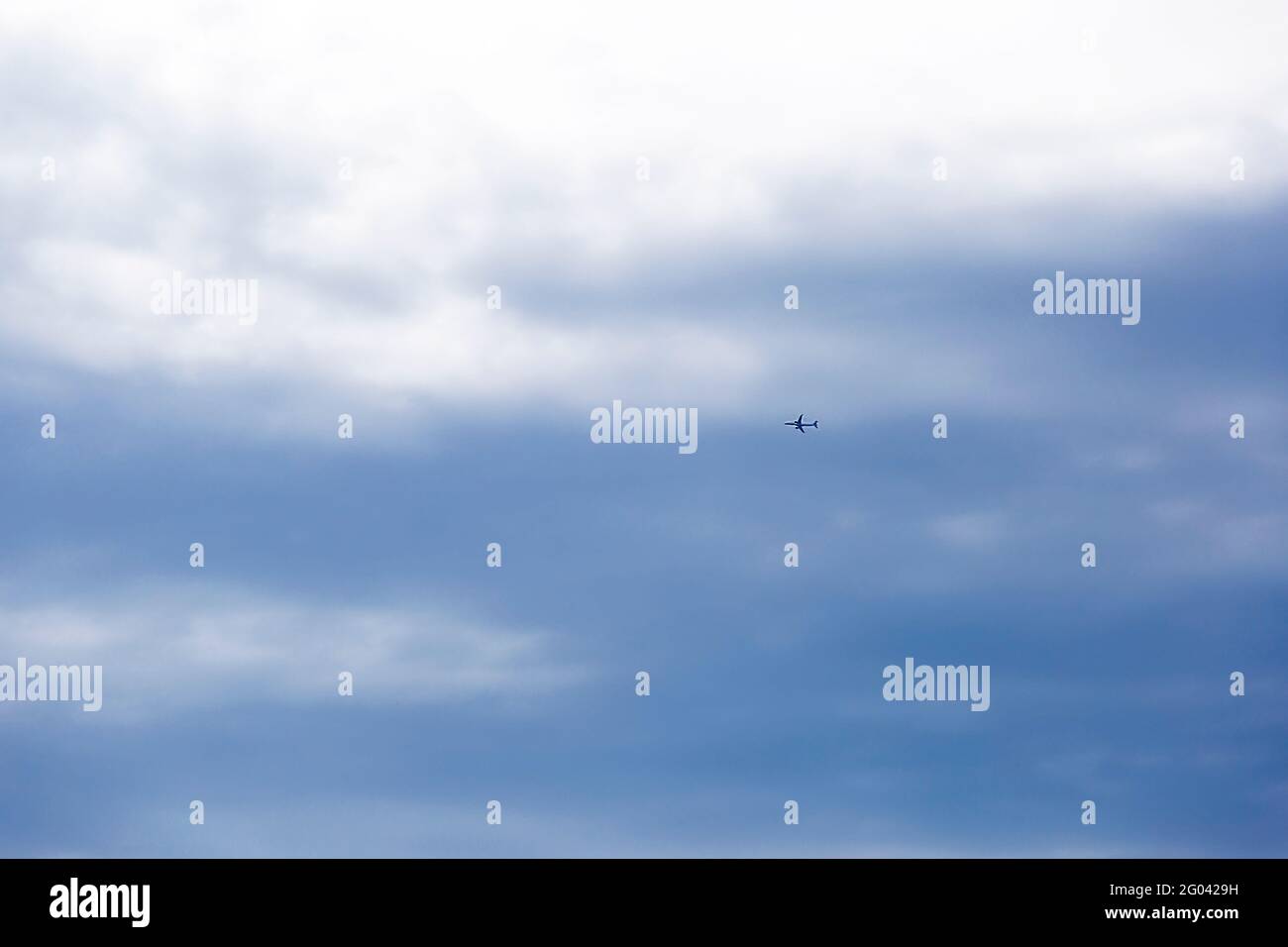 view from the bottom of a passenger plane taking off or landing against ...