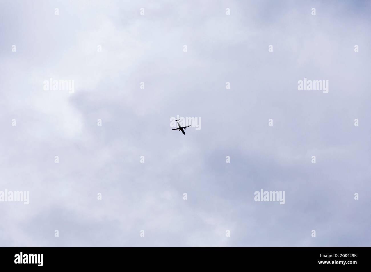 bottom view, a black passenger plane taking off or landing against a ...