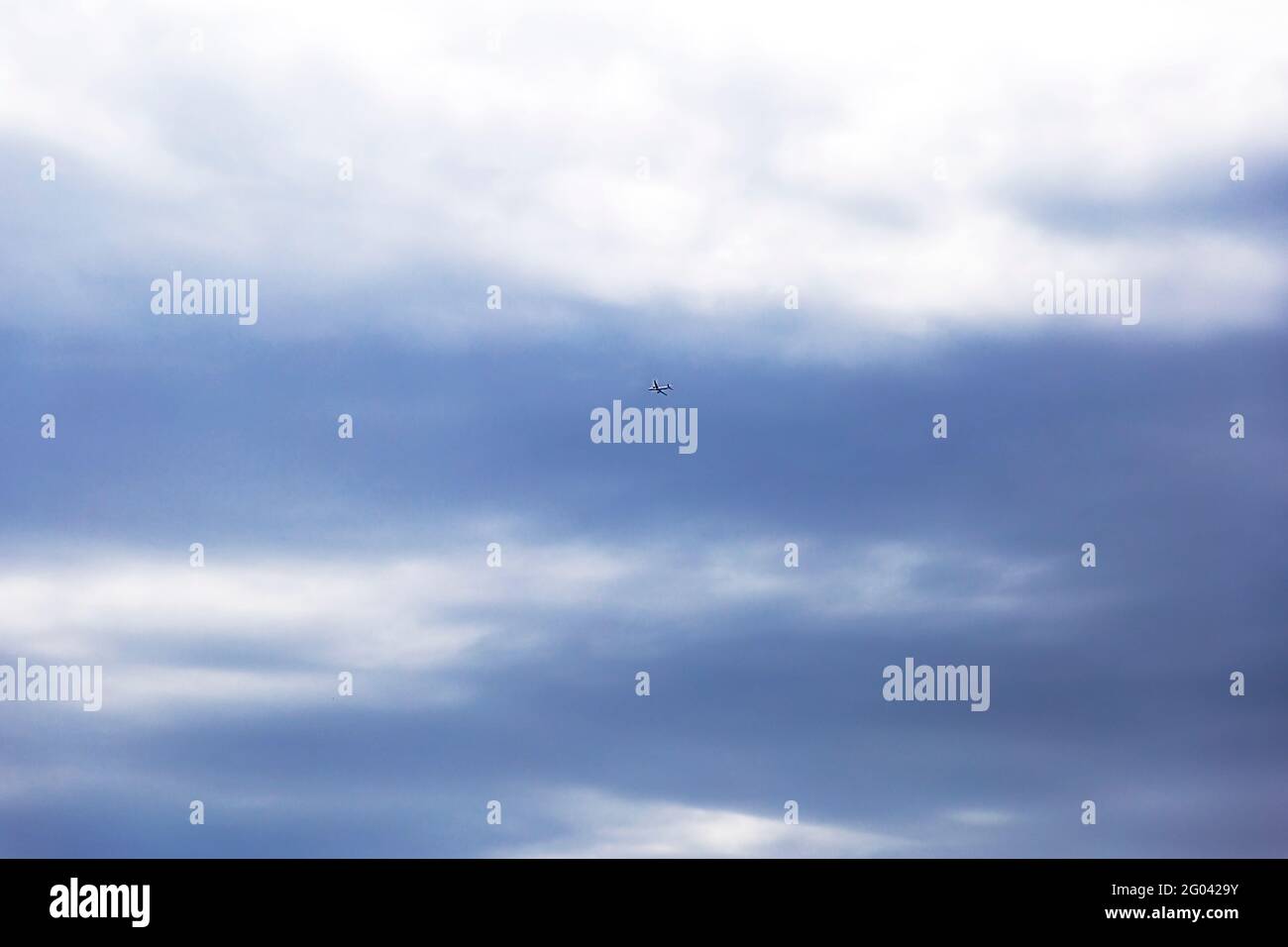 view from the bottom of a passenger plane taking off or landing against ...
