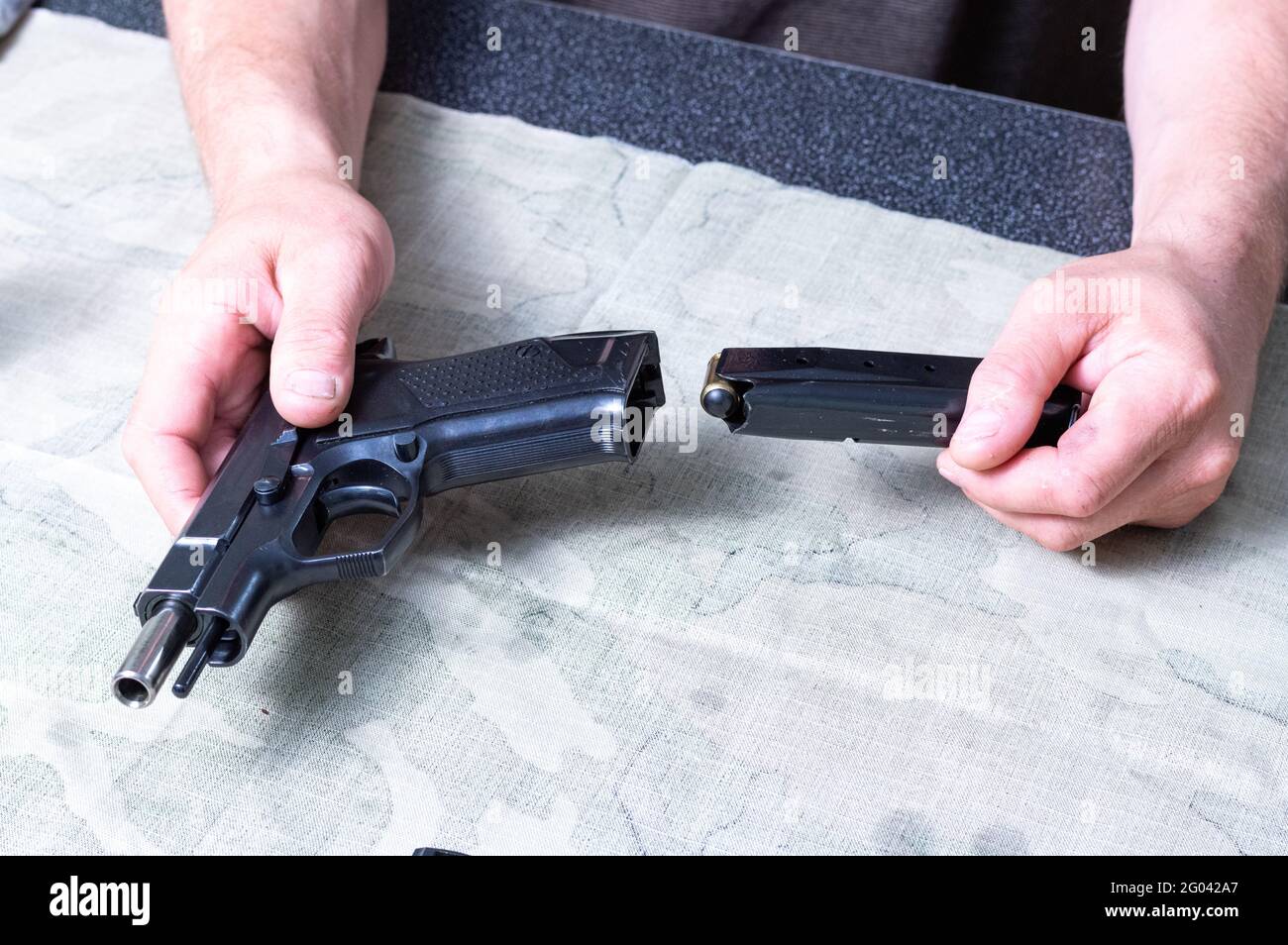 The owner of the pistol inserts the magazine into the pistol. Load the ...