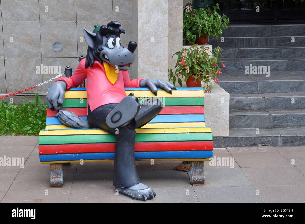 Sculpture of a wolf on a bench from a Soviet cartoon in front of the ...