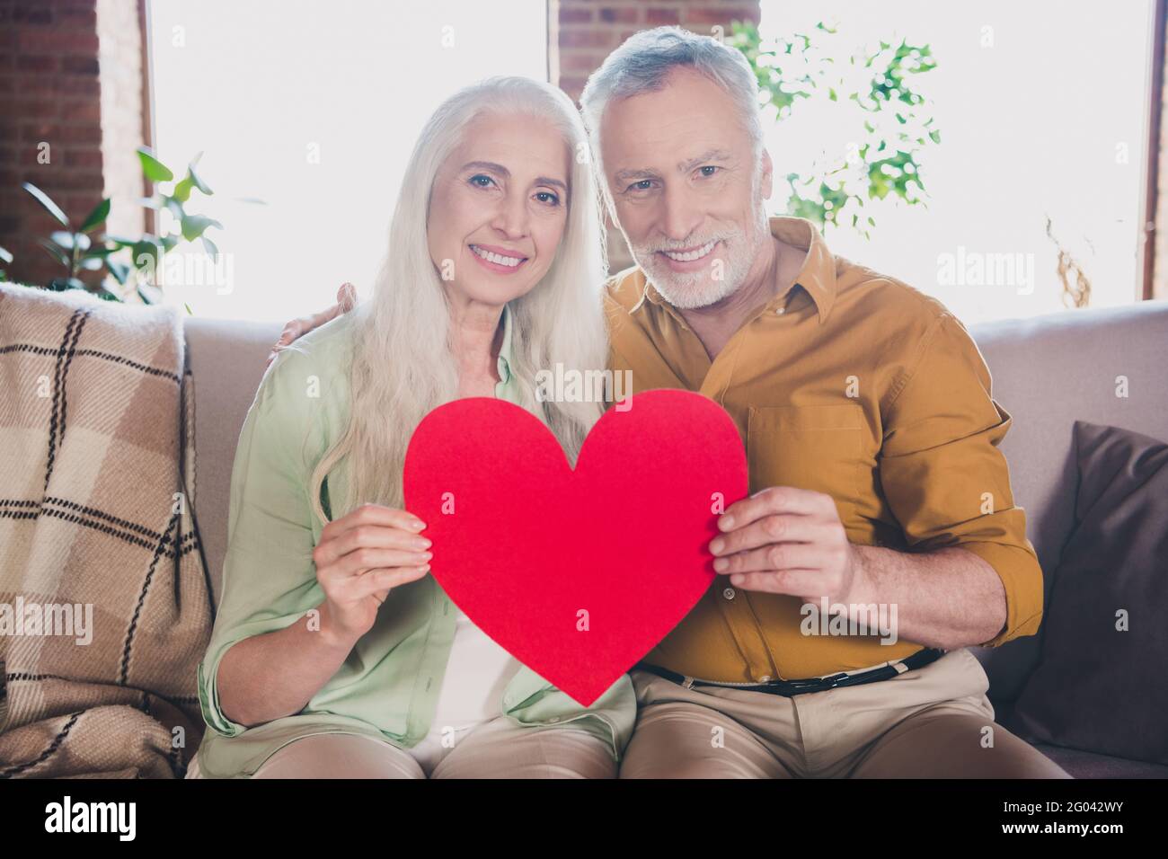 Photo of adorable cheerful pensioner lady gentleman sitting couch ...