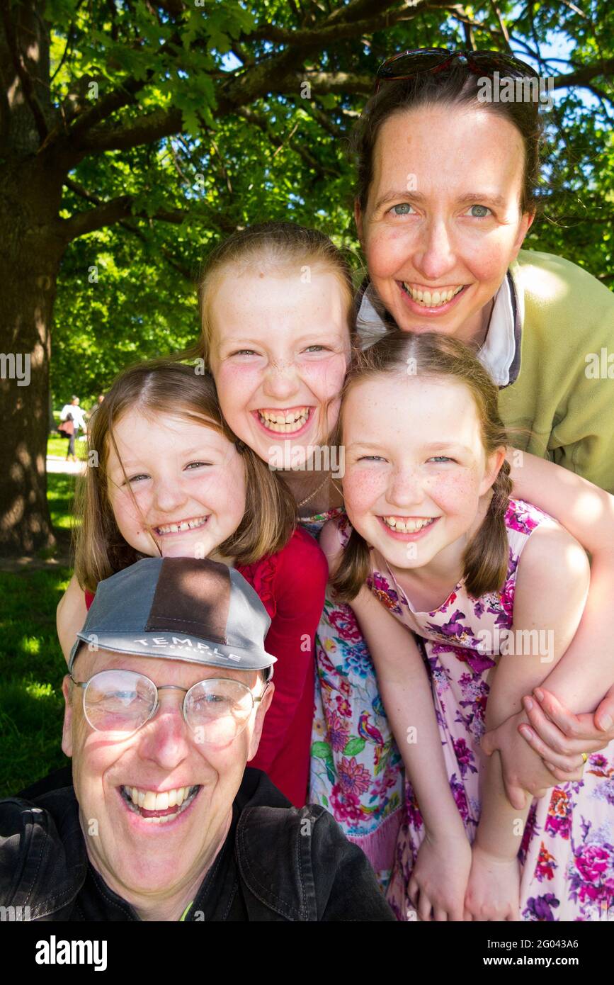 Mother – mum, father – dad, & 3 children / three kids daughters pose ...