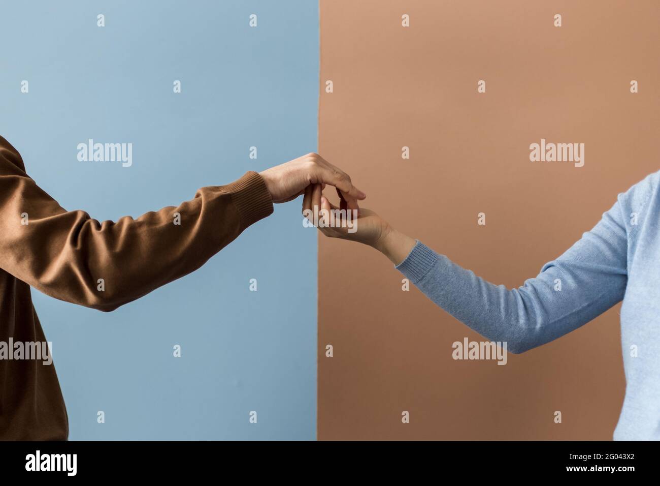 Two hands merge with tips of the fingers into a fist on different ...