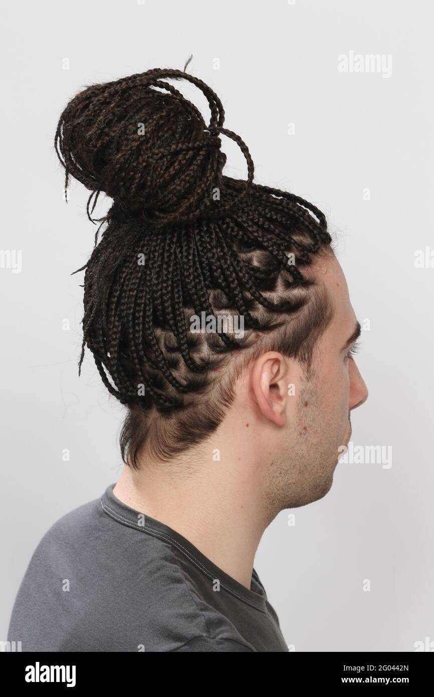 Stylish male model with afro braids posing in studio on isolated ...