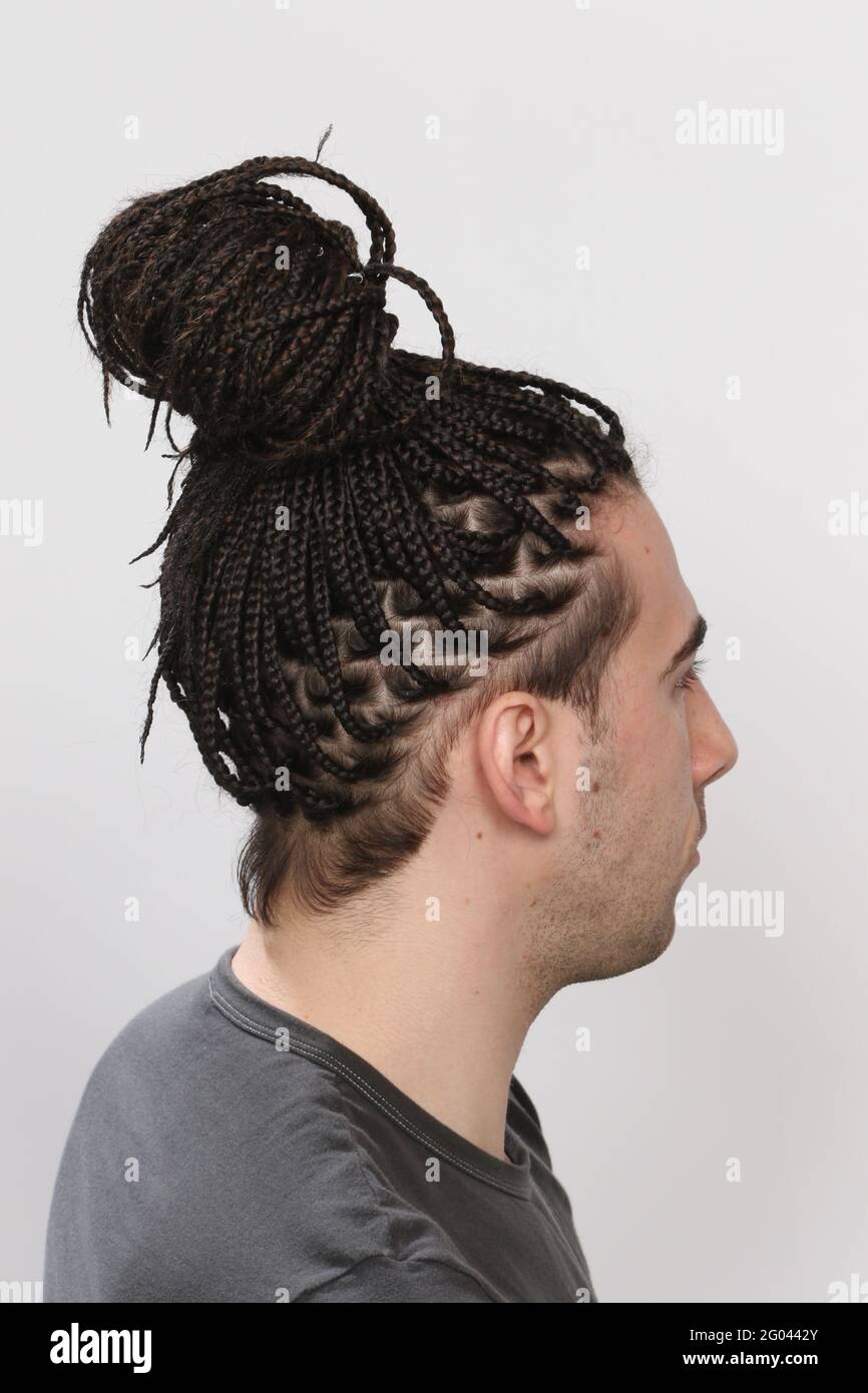 Stylish male model with afro braids posing in studio on isolated ...