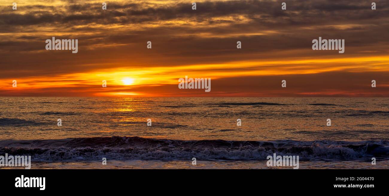 A beautiful and dramatic sunrise on the beach Stock Photo - Alamy