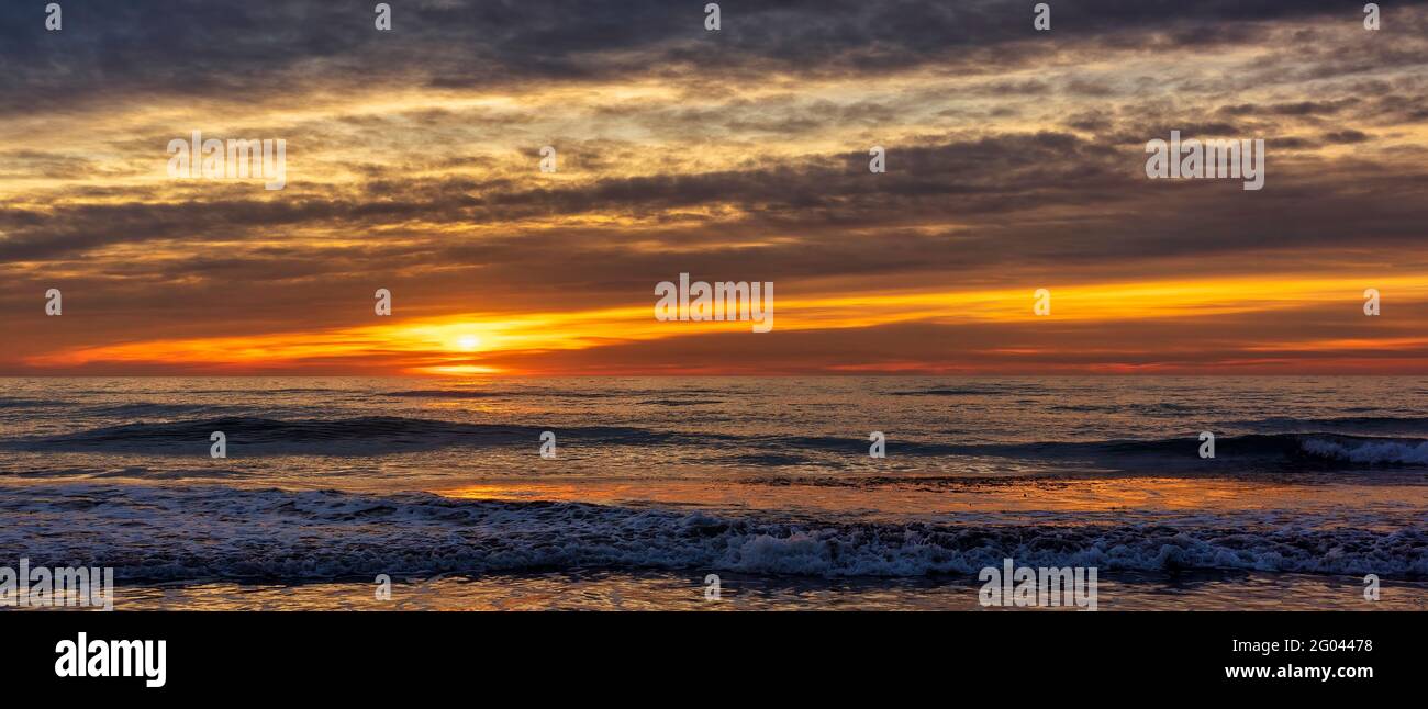 A beautiful and dramatic sunrise on the beach Stock Photo - Alamy