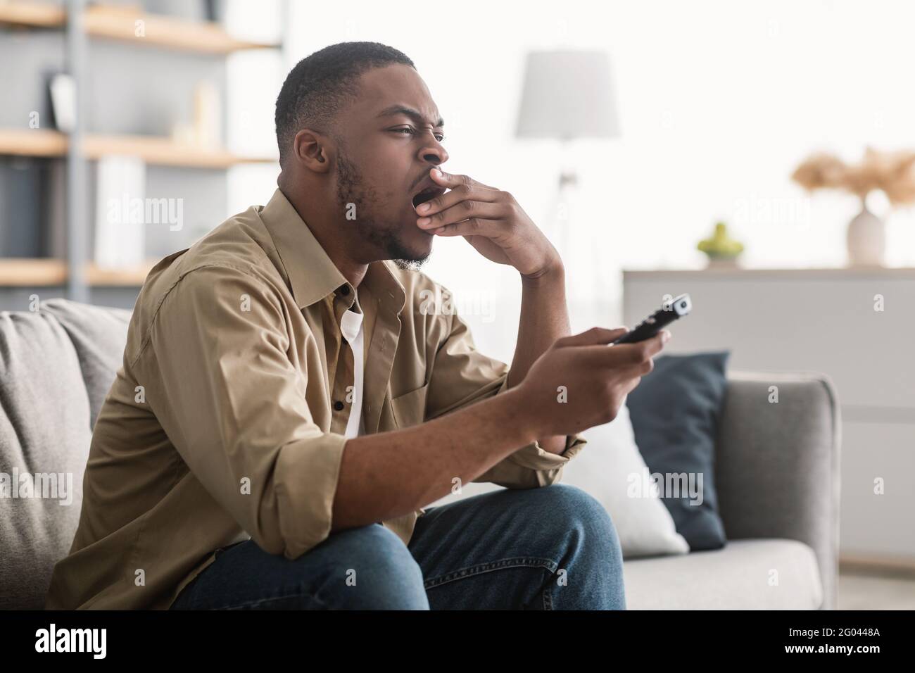Bored guy sitting on couch hi-res stock photography and images - Alamy