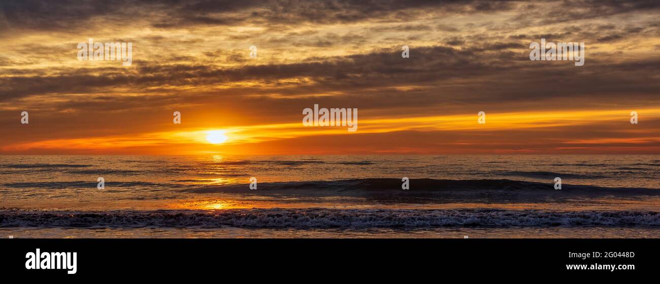 A beautiful and dramatic sunrise on the beach Stock Photo - Alamy