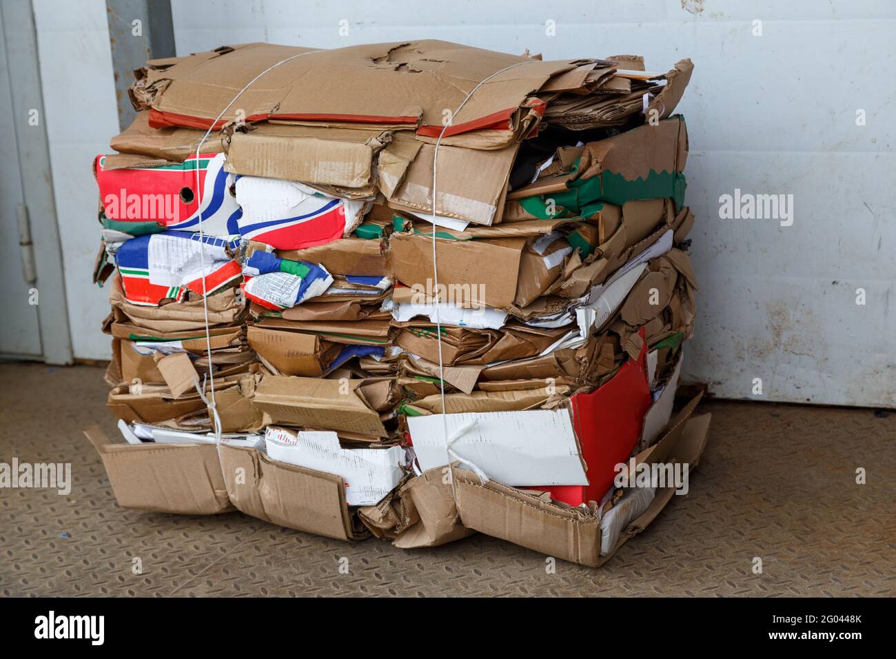 compressed cardboard waste bales compacted in a block behind grocery ...