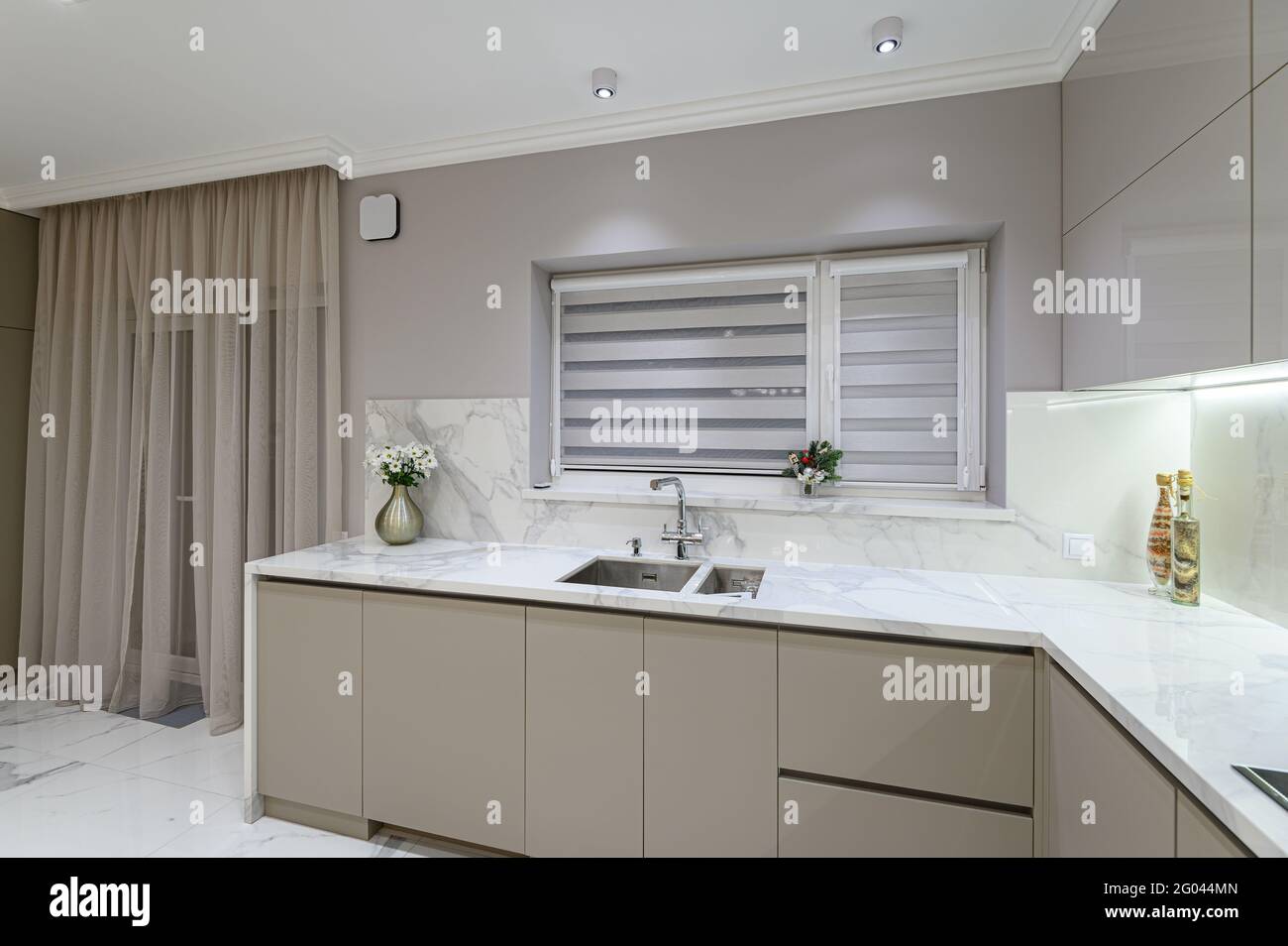 Luxury white modern marble kitchen in studio space Stock Photo - Alamy
