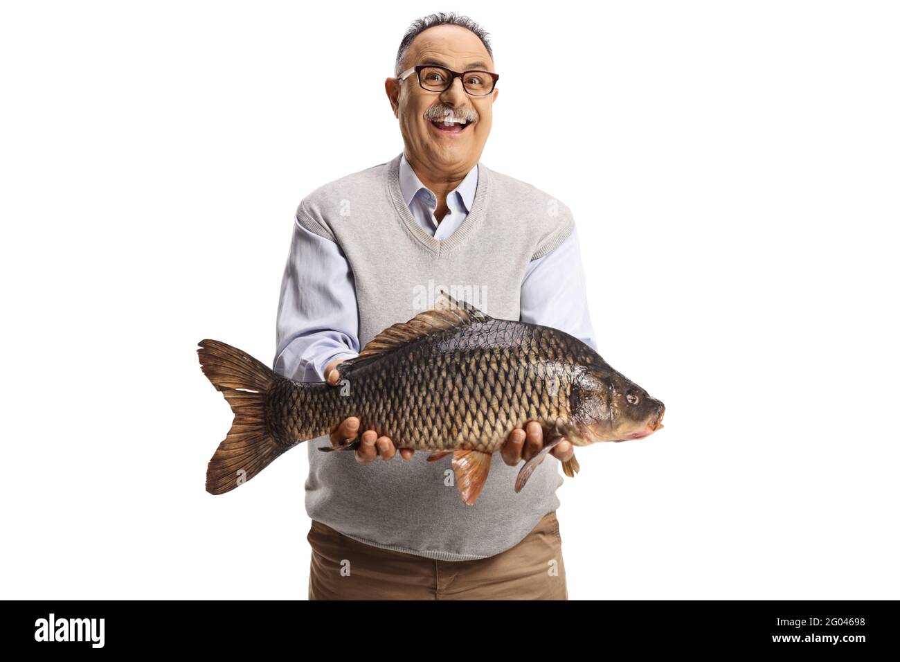 Excited mature casual man holding a big carp fish isolated on white ...